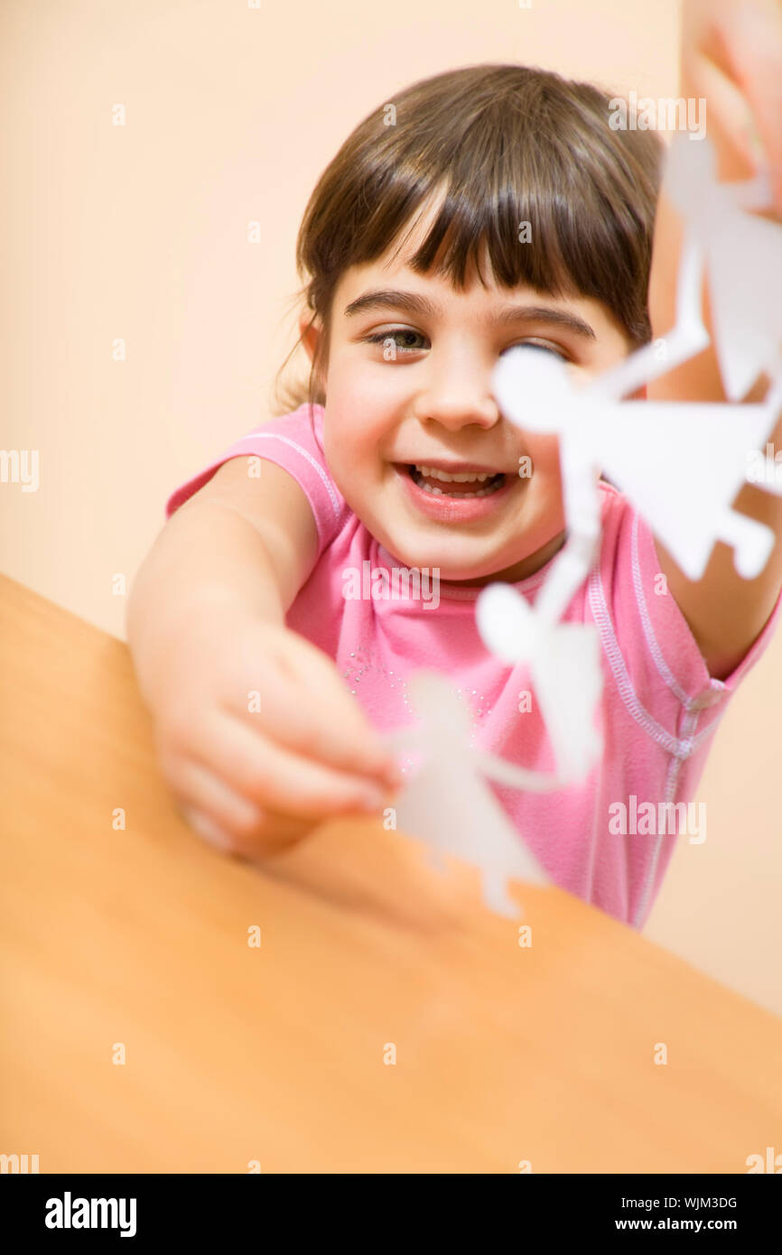 little girl playing with paper dolls Stock Photo - Alamy