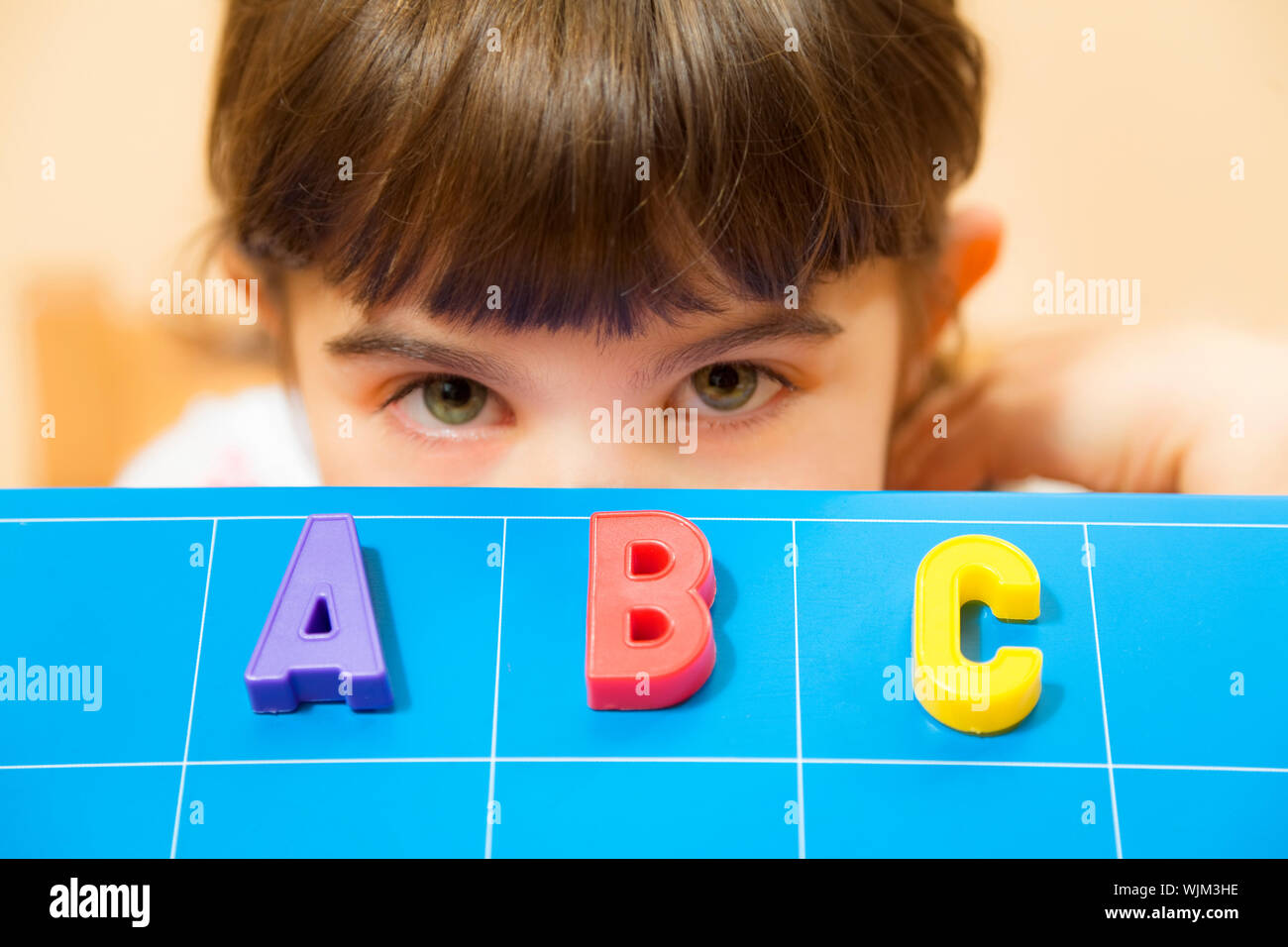child learning the ABC's. The focus is on the letters Stock Photo - Alamy