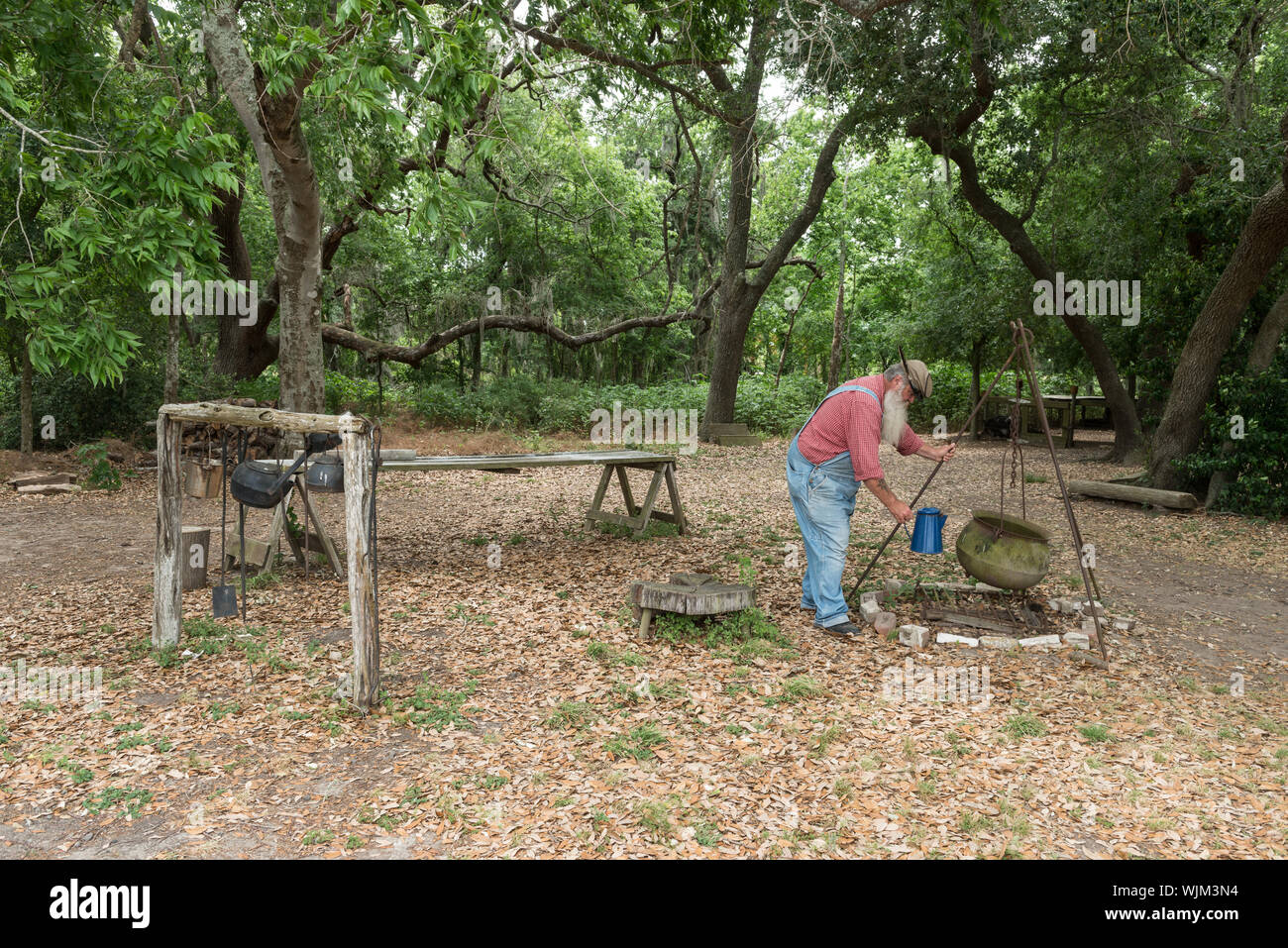 Historical interpreter Uncle Bob Beringer tends to a crude outdoor ...