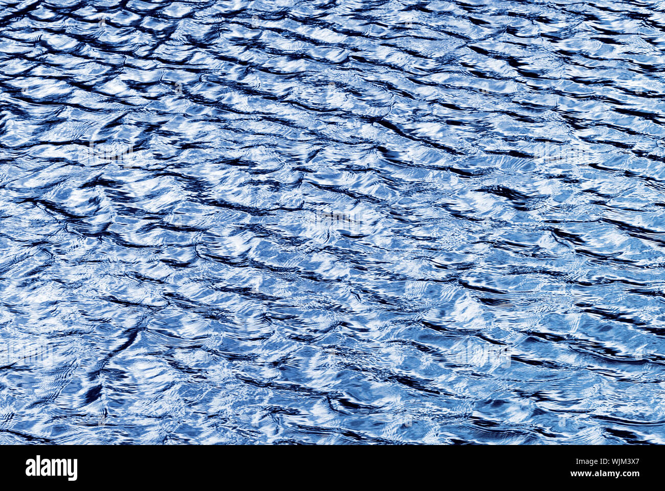 Abstract background of blue water surface with ripples Stock Photo - Alamy