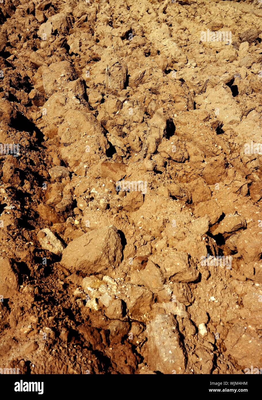 Agriculture field red clay soil texture macro Stock Photo - Alamy