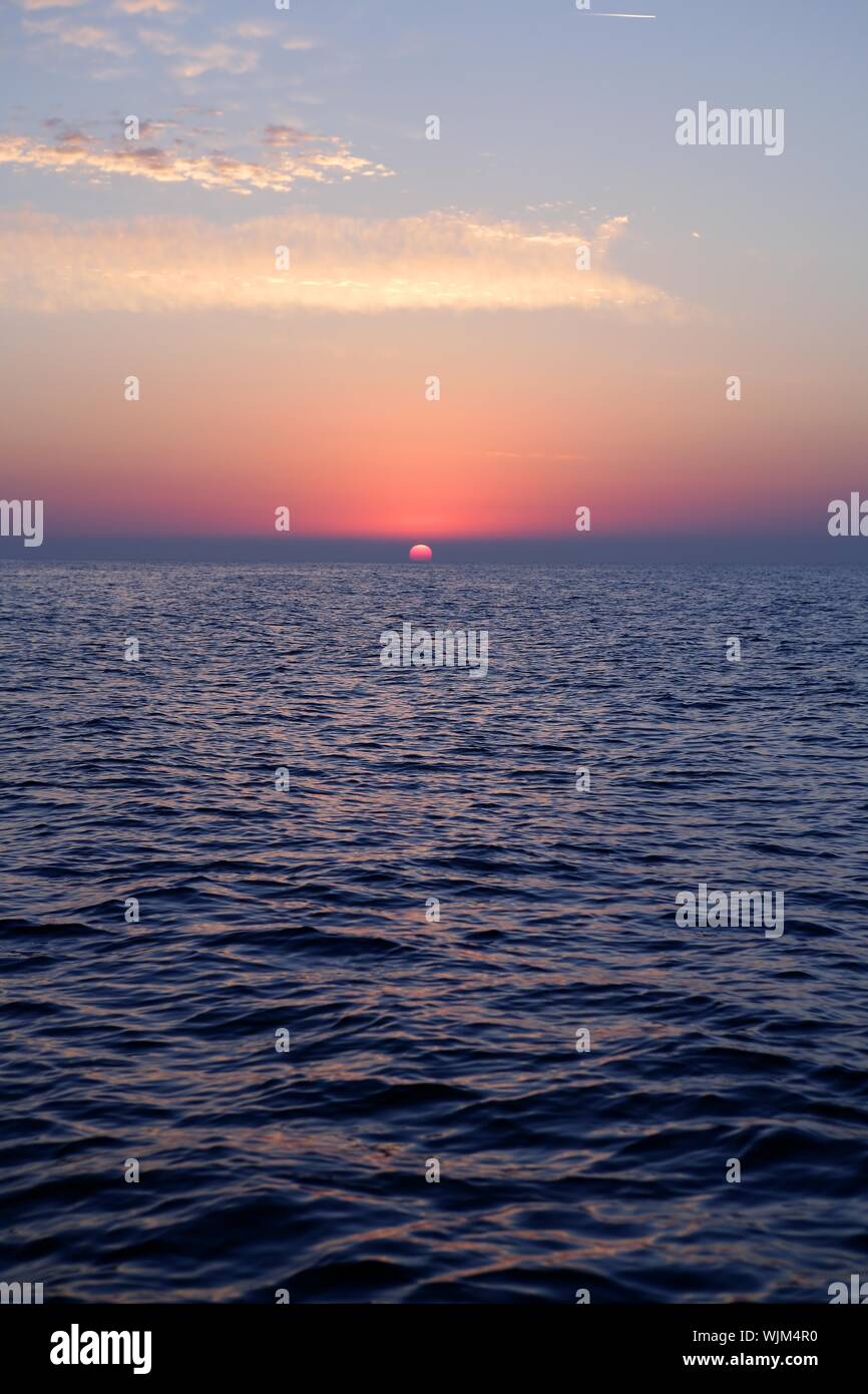 Sunrise at mediterranean sea. Red horizon, blue water Stock Photo - Alamy