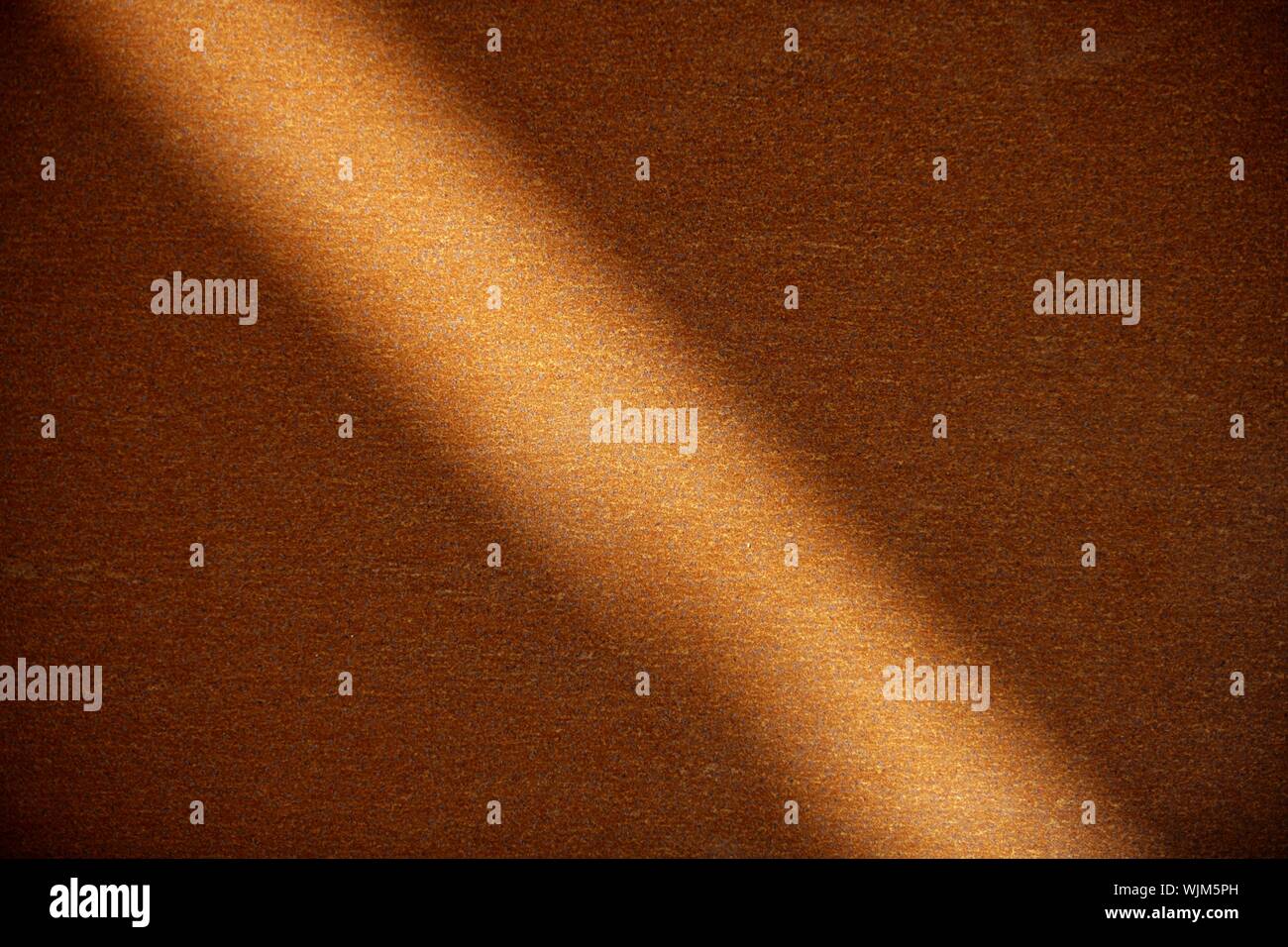 Rusted steel orange background texture. Beam of light crossing surface ...