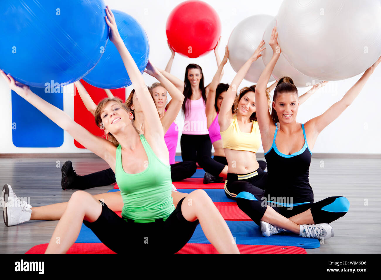 image of people doing stretching exercise with fitness balls Stock ...