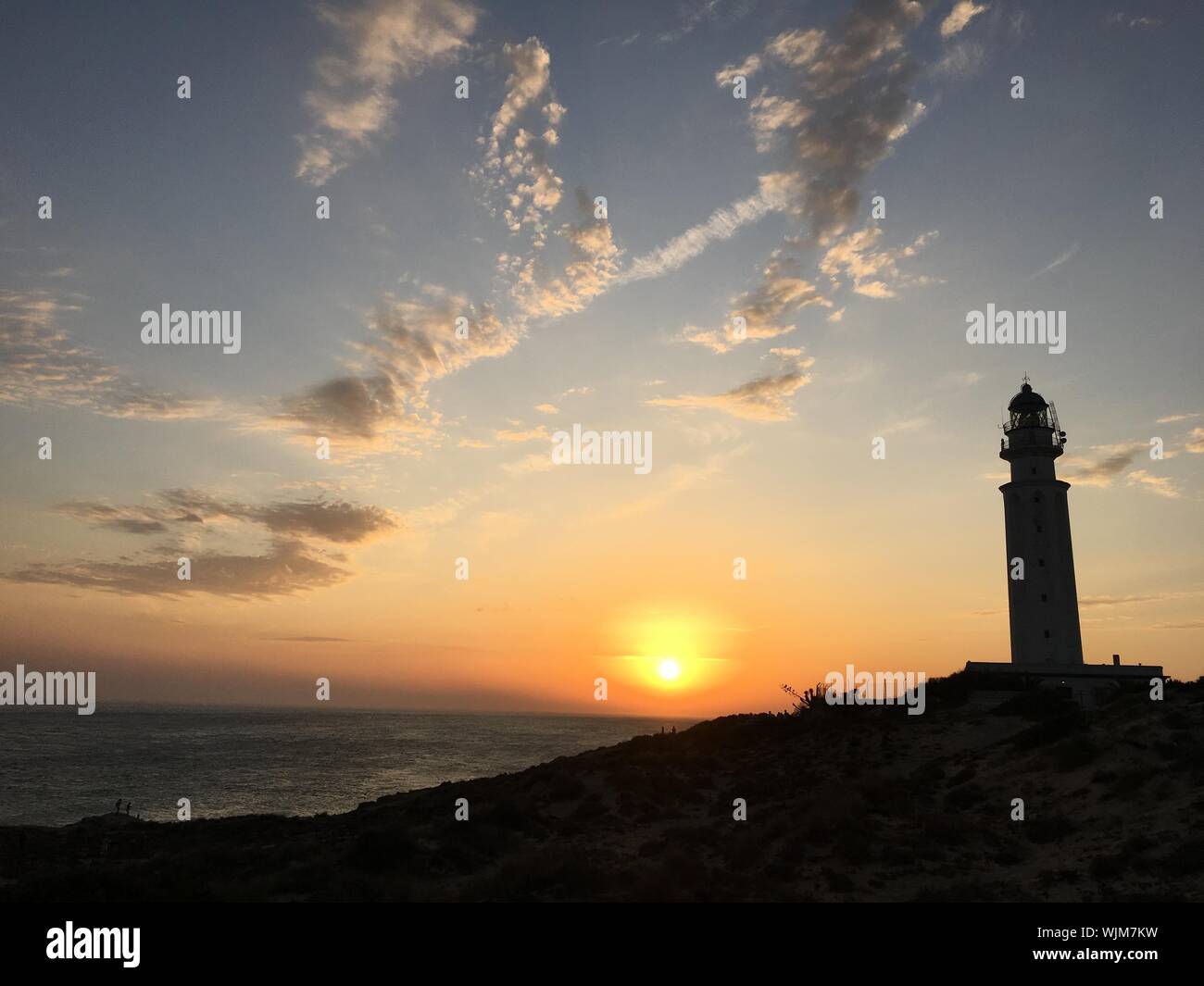 Trafalgar lighthouse on the coast of Cadiz at sunset Stock Photo - Alamy