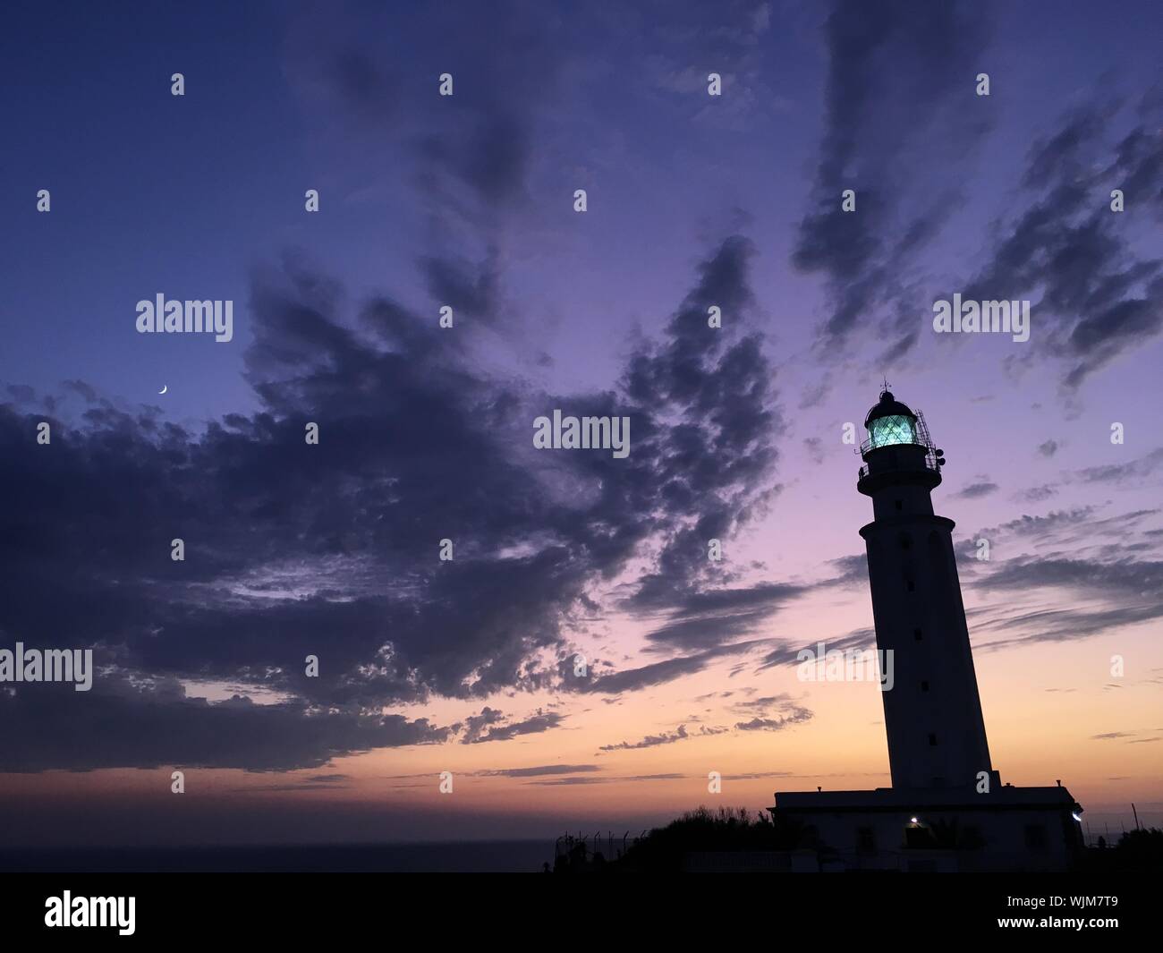 Trafalgar lighthouse on the coast of Cadiz at sunset Stock Photo - Alamy