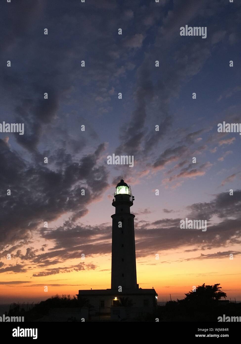 Trafalgar lighthouse on the coast of Cadiz at sunset Stock Photo - Alamy