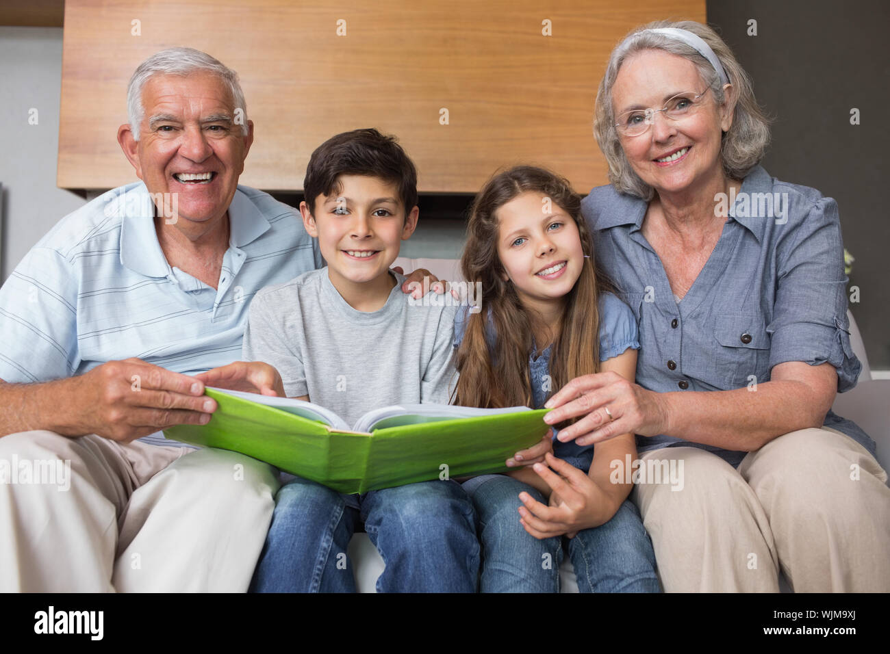 Grandmother grandchildren looking album hi-res stock photography and ...