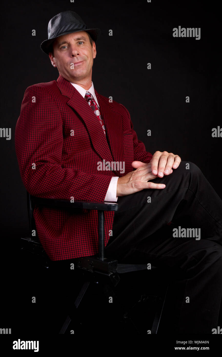 Man sitting in directors chair Stock Photo - Alamy