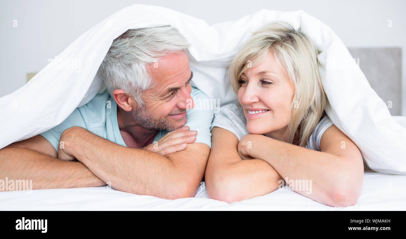 Closeup portrait of a mature couple lying in bed at home Stock Photo ...