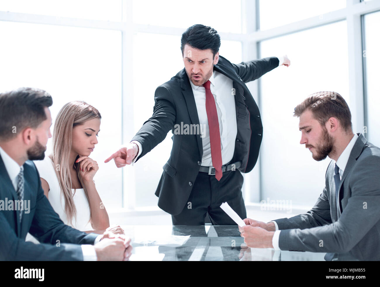 Strict boss telling upset female employee to leave meeting room Stock ...