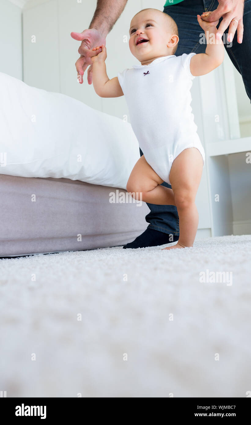 Father teaching baby to walk hi-res stock photography and images - Alamy