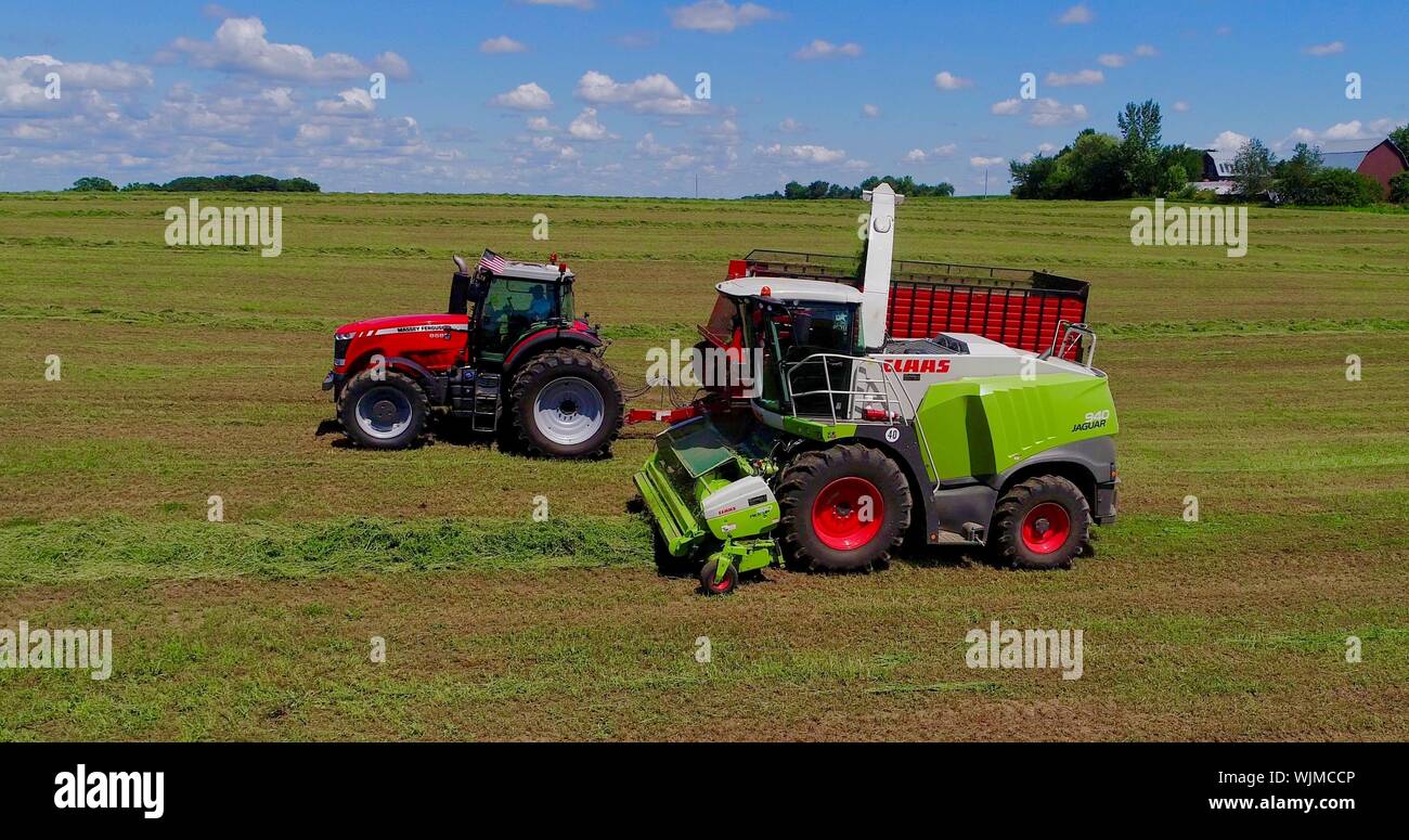 Aerial view of Massey Ferguson 1880 tractor pulling hay wagon, with ...