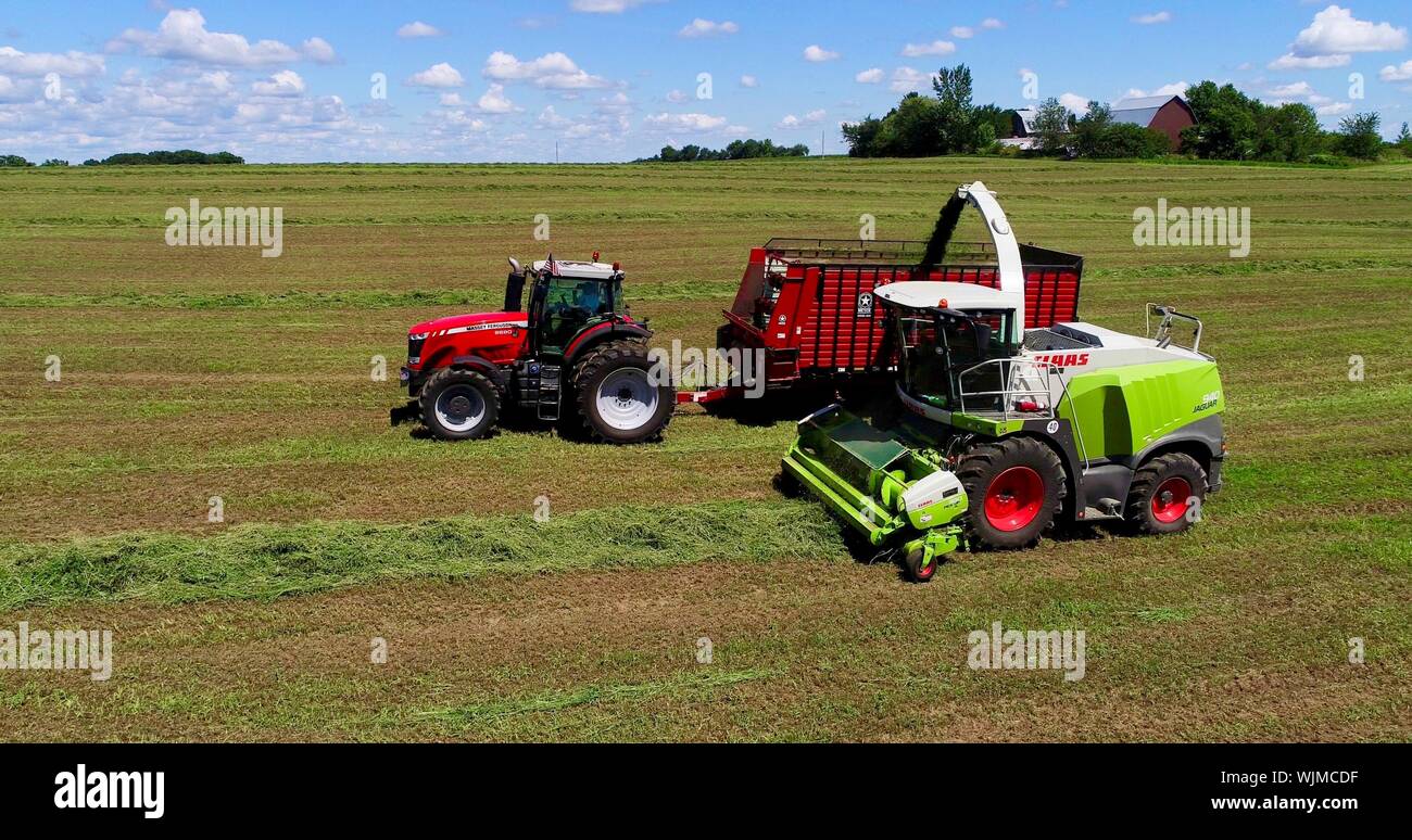 Aerial view of Massey Ferguson 1880 tractor pulling hay wagon, with ...