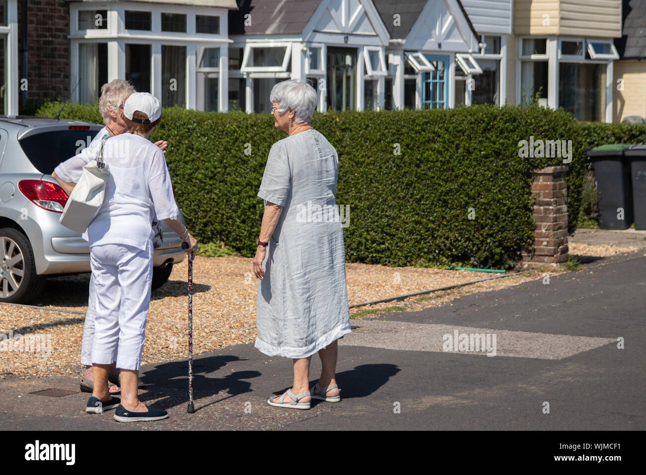 Three elderly women talking in the street Stock Photo - Alamy