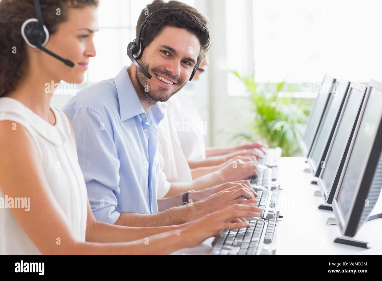 Customer service colleagues using headset hi-res stock photography and ...