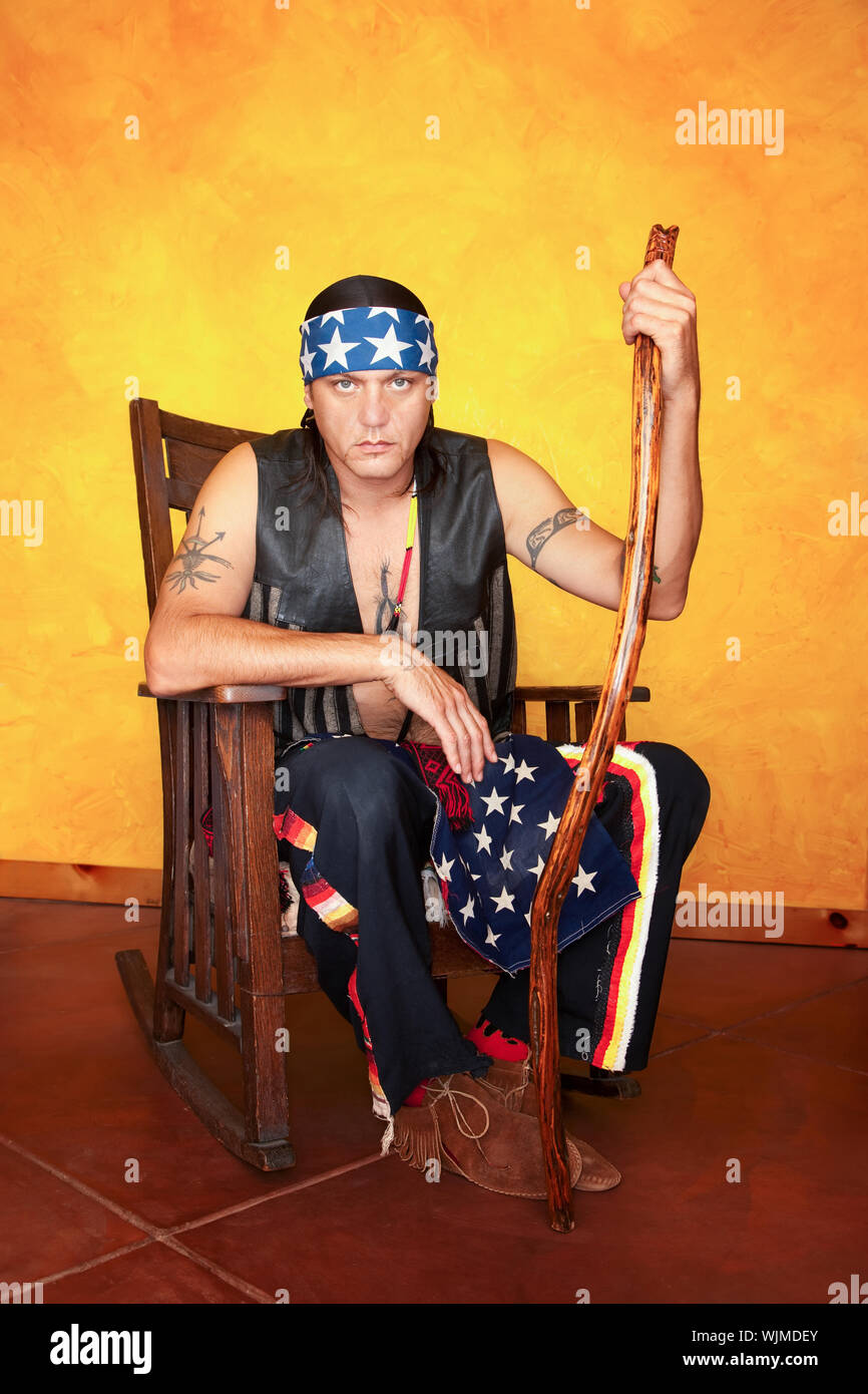 Kneeling Native American man in rocking chair Stock Photo - Alamy