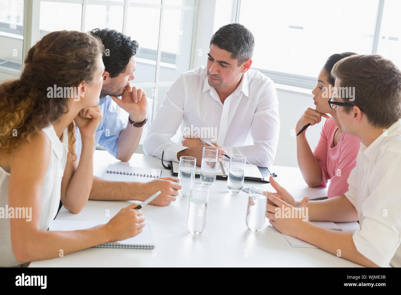 Business people discussing at conference table in office Stock Photo ...