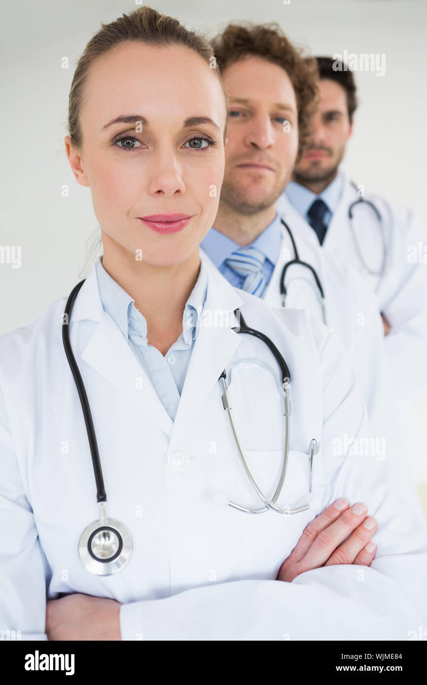 Portrait of confident doctors standing in a row at hospital Stock Photo ...