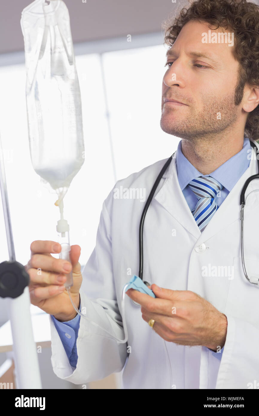 Professional doctor examining intravenous drip in hospital Stock Photo ...
