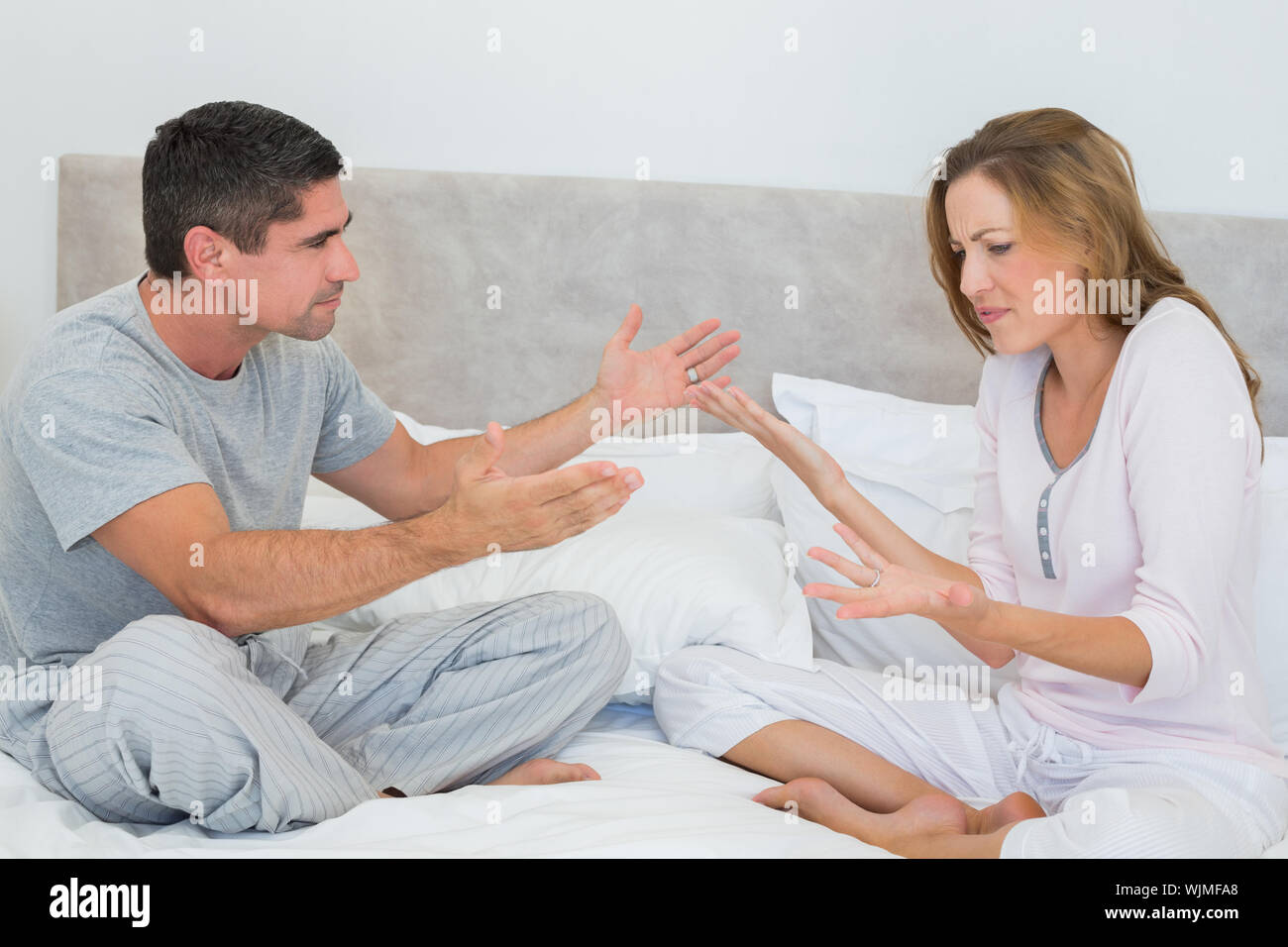 Frustrated couple arguing in bedroom Stock Photo - Alamy