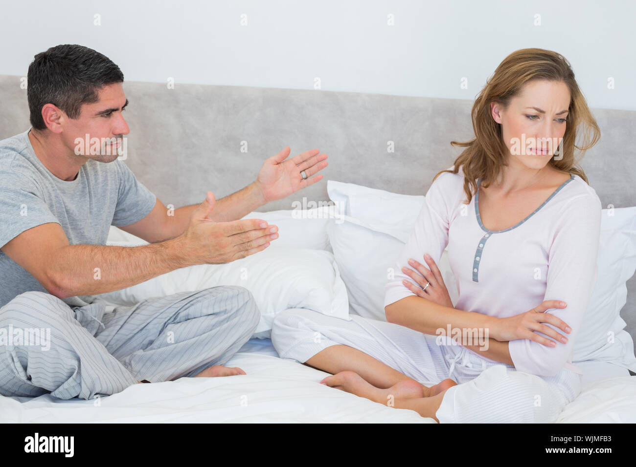 Mid adult couple fighting in bedroom Stock Photo - Alamy