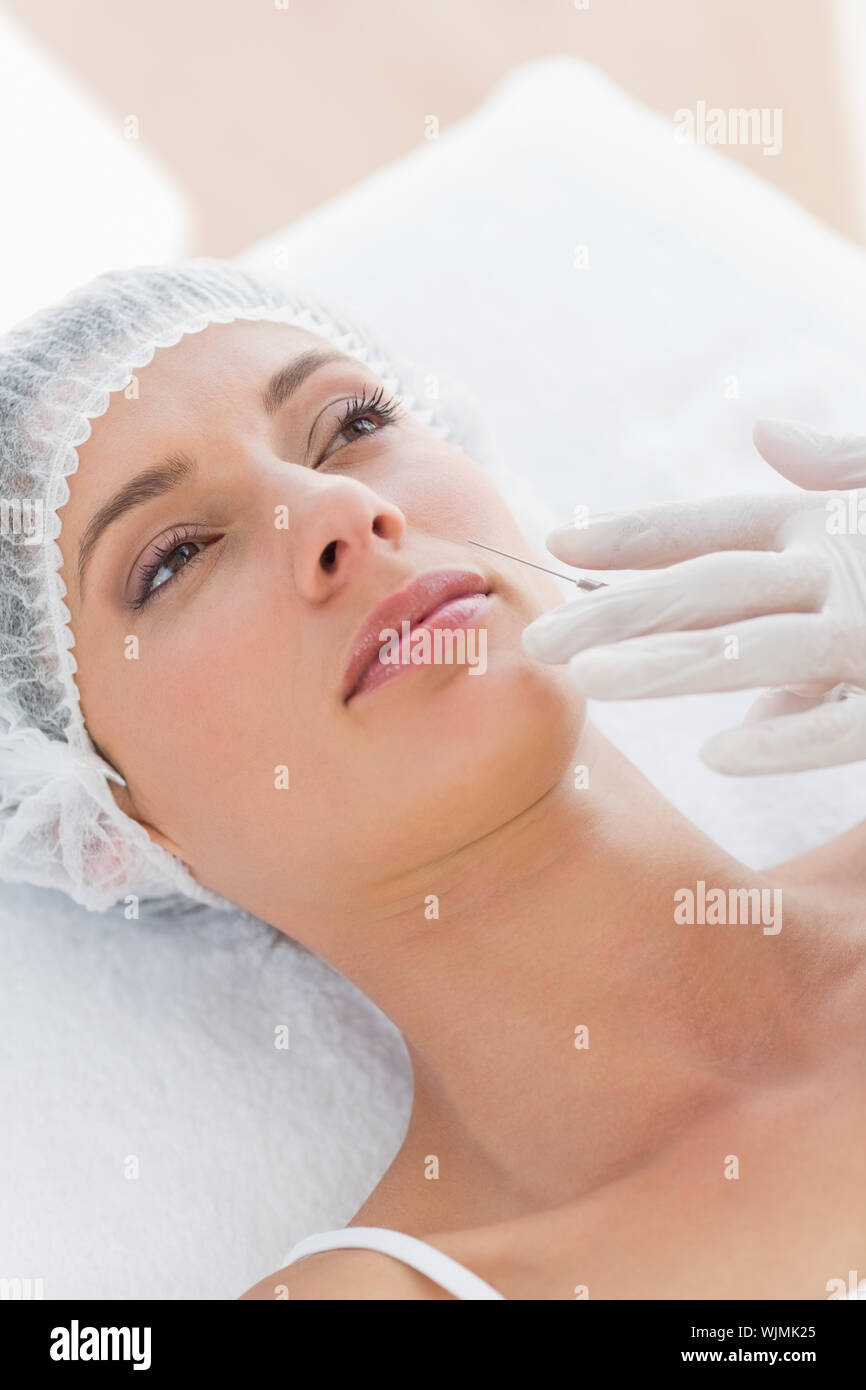 Beautiful young woman recieving botox injection in hospital Stock Photo ...