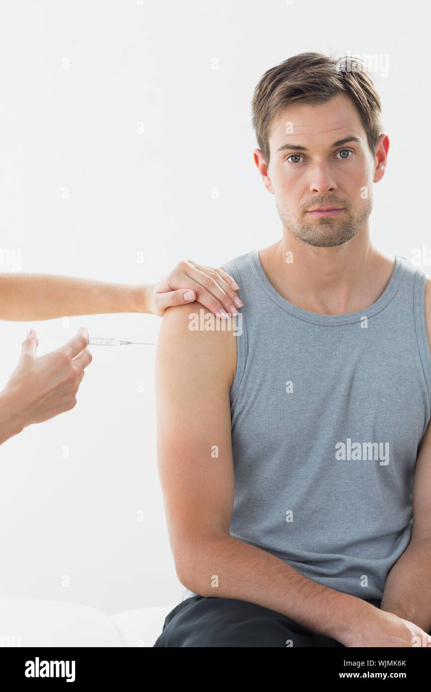Portrait of man receiving injection on arm in hospital Stock Photo - Alamy