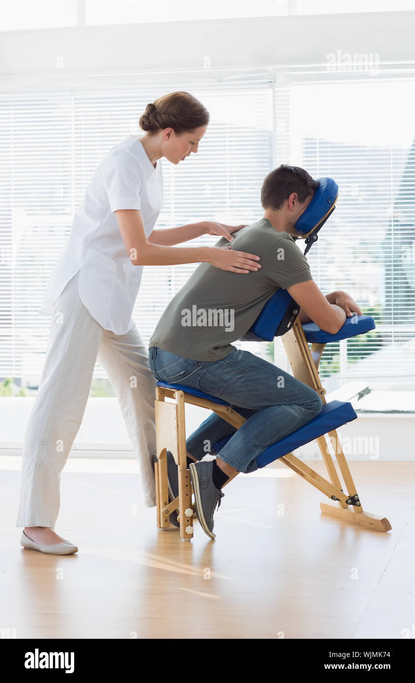 Woman sitting in chair massaging hi-res stock photography and images ...