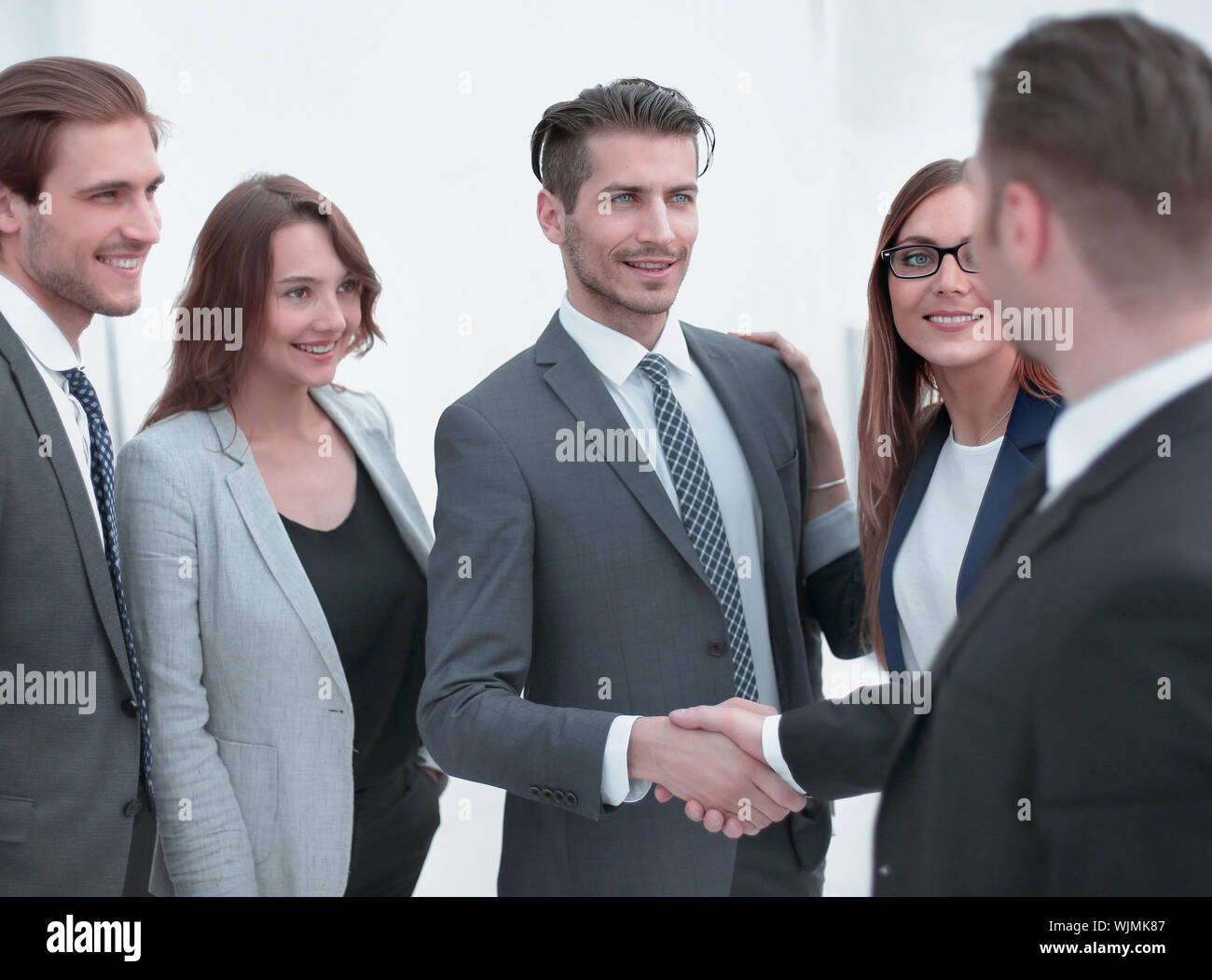 handshake in the lobby of an office building Stock Photo - Alamy