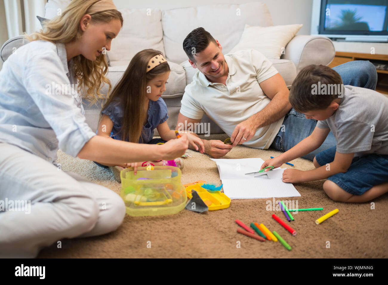 Family assisting boy in drawing at home Stock Photo - Alamy
