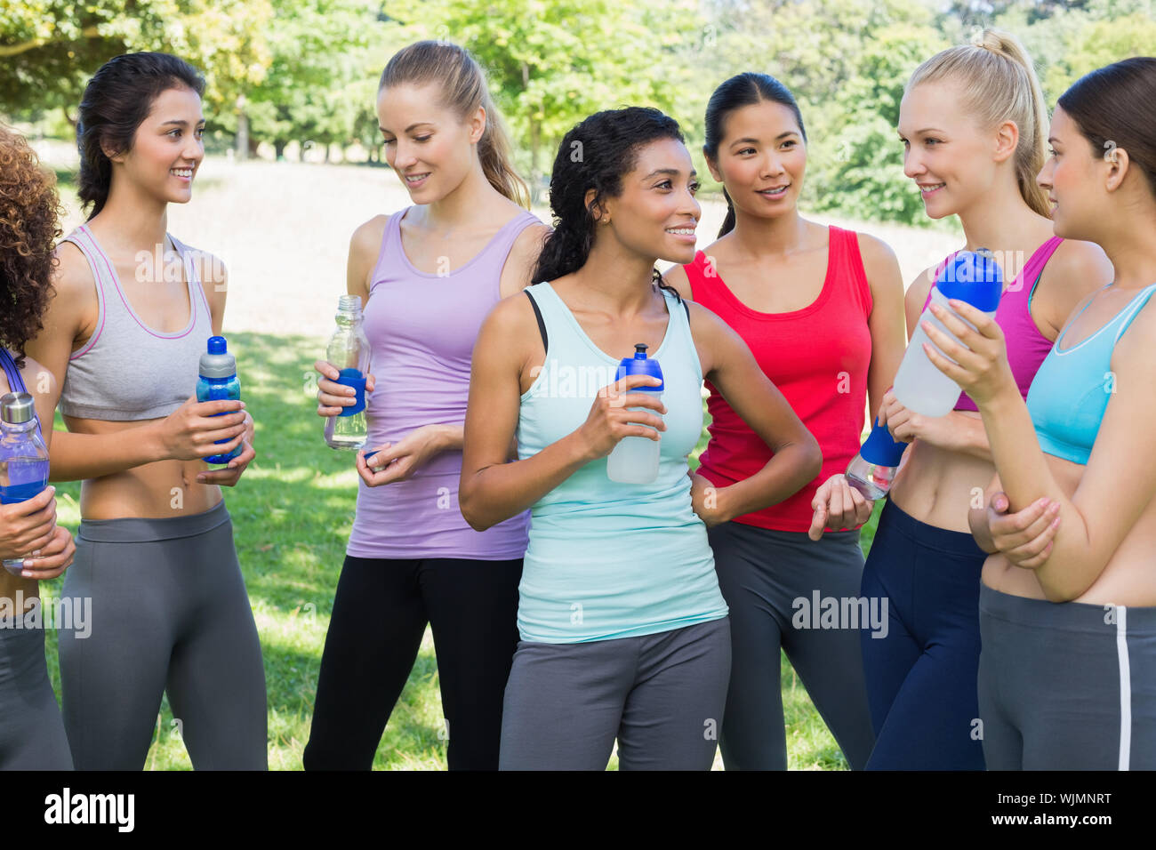 Smiling friends water bottles talking hi-res stock photography and ...