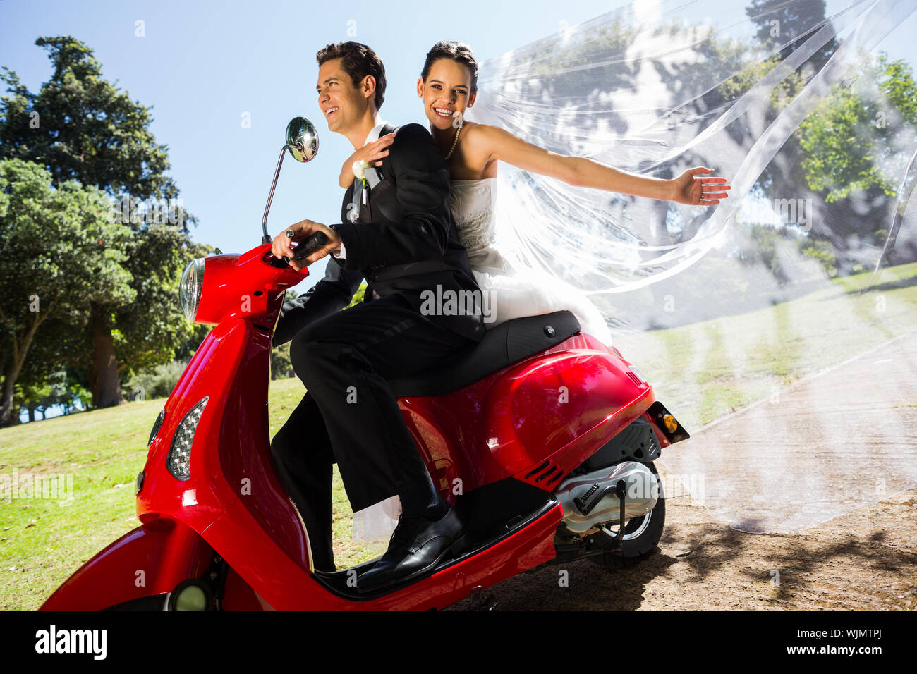 Side view portrait of a newlywed couple enjoying scooter ride Stock ...