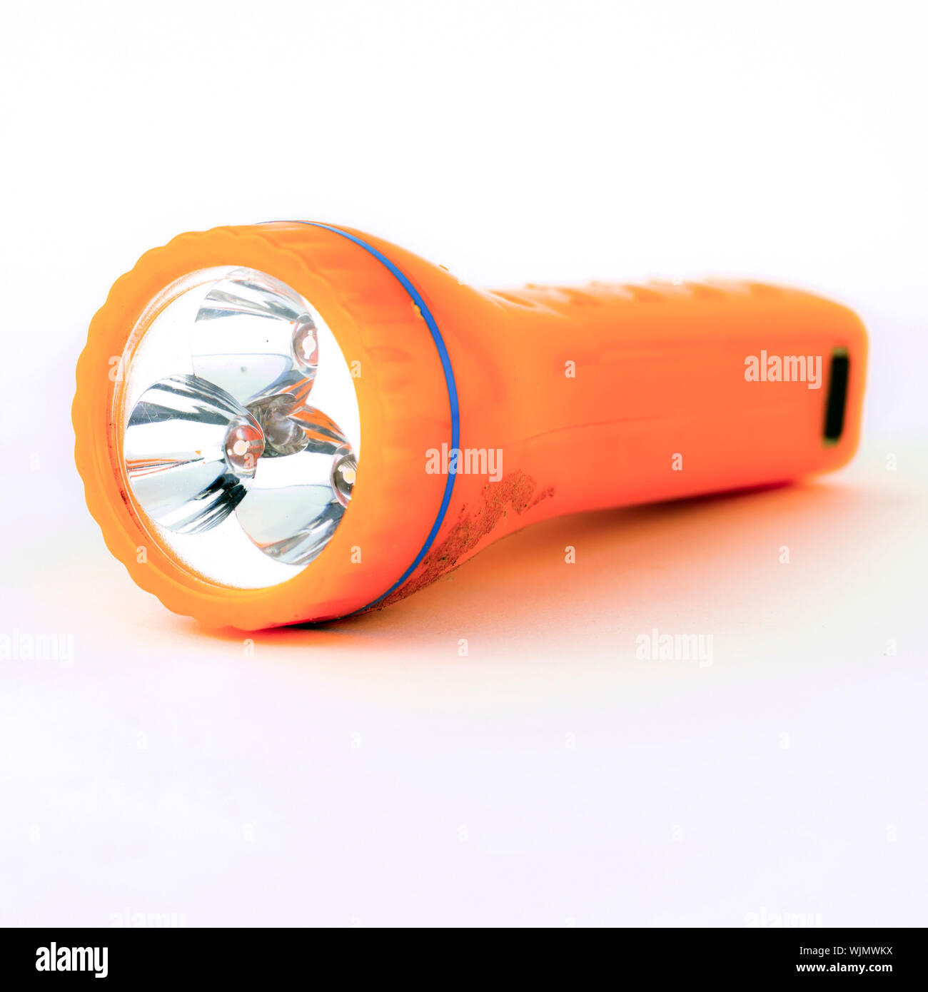 used orange flashlight isolated on white background Stock Photo - Alamy