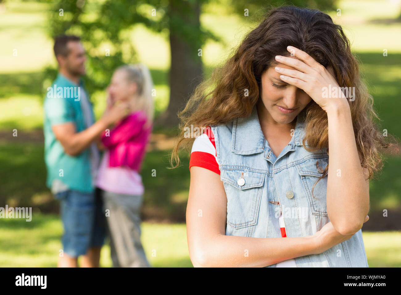 Portrait of an angry woman with man and girlfriend in background at the ...