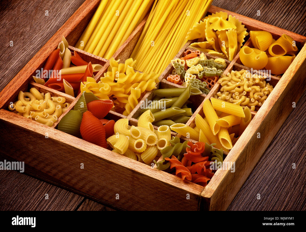 Various Raw Dry Pasta in Wooden Box Cross Section on Rustic Wooden ...