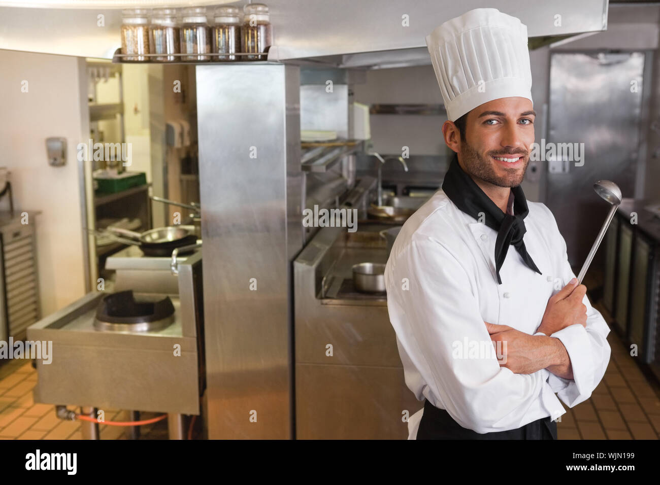 Cheerful chef holding ladle hi-res stock photography and images - Alamy