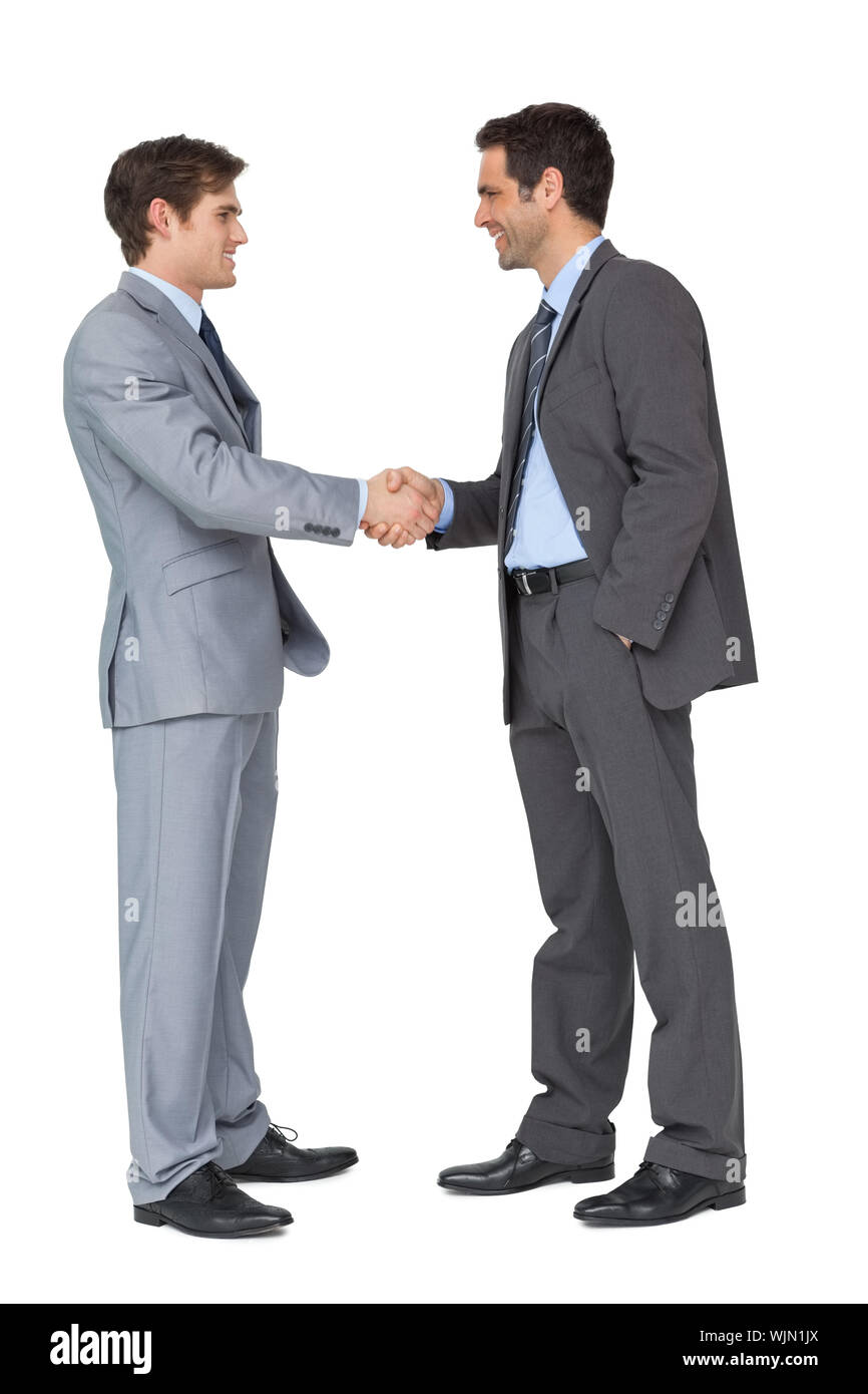 Happy business partners shaking hands on white background Stock Photo ...