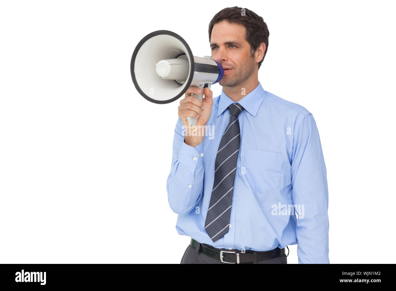 Handsome businessman talking through megaphone on white background ...