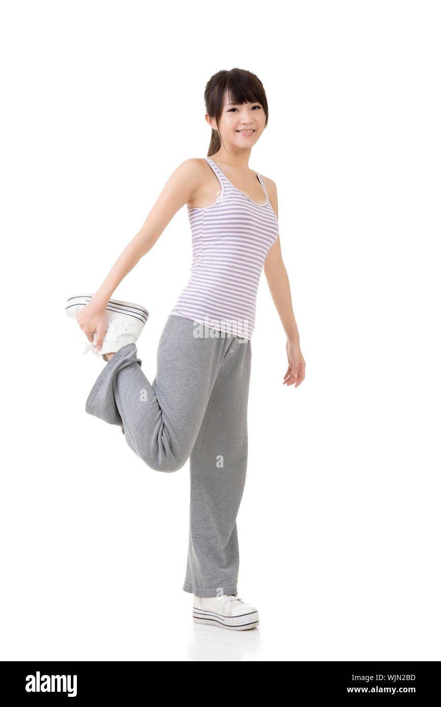 Fitness asian girl doing stretch exercise. Full length portrait ...