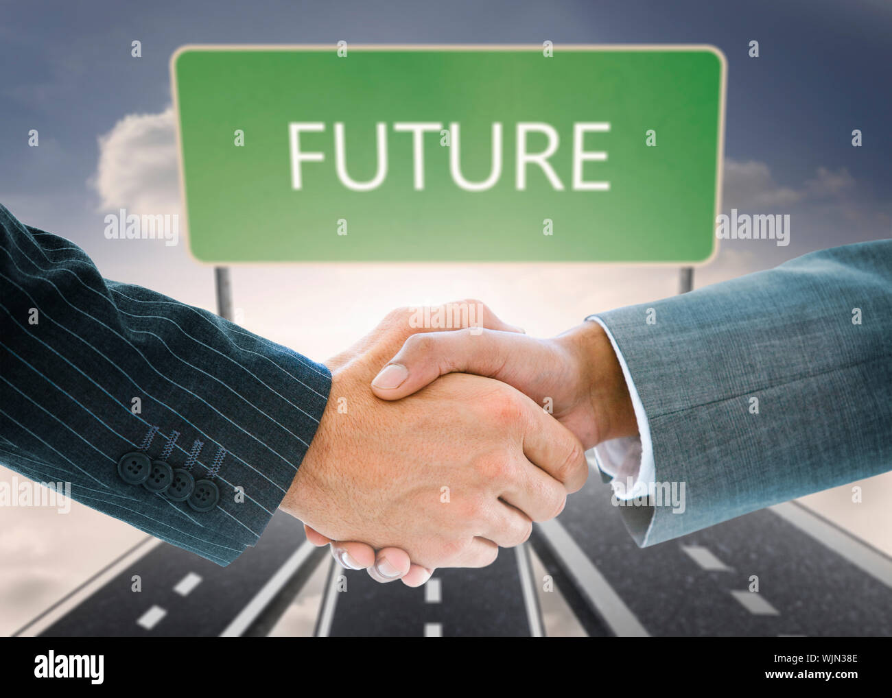 Composite image of business handshake against signpost showing the ...