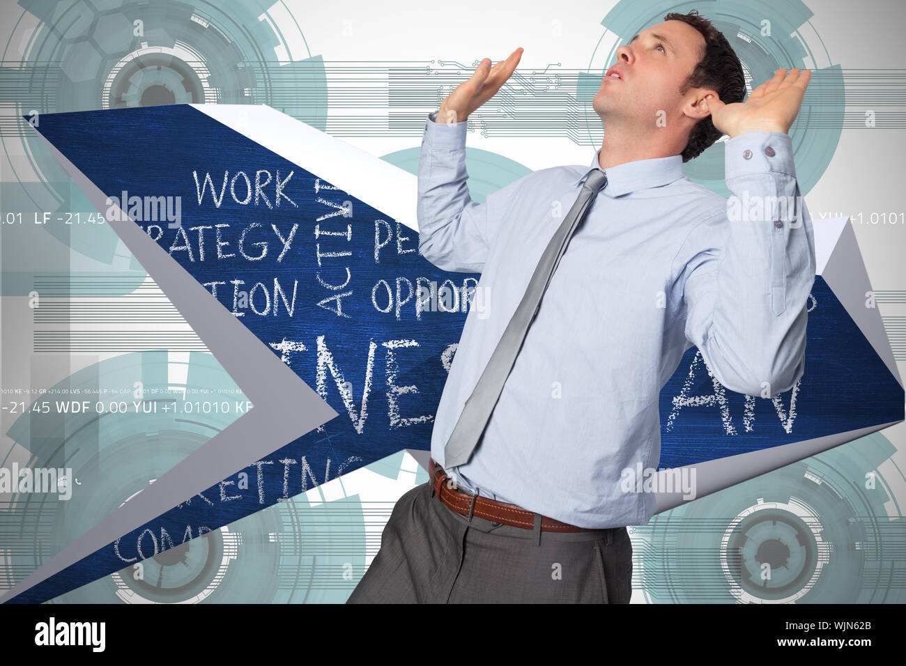 Businessman standing with arms pushing up against technology wheel ...