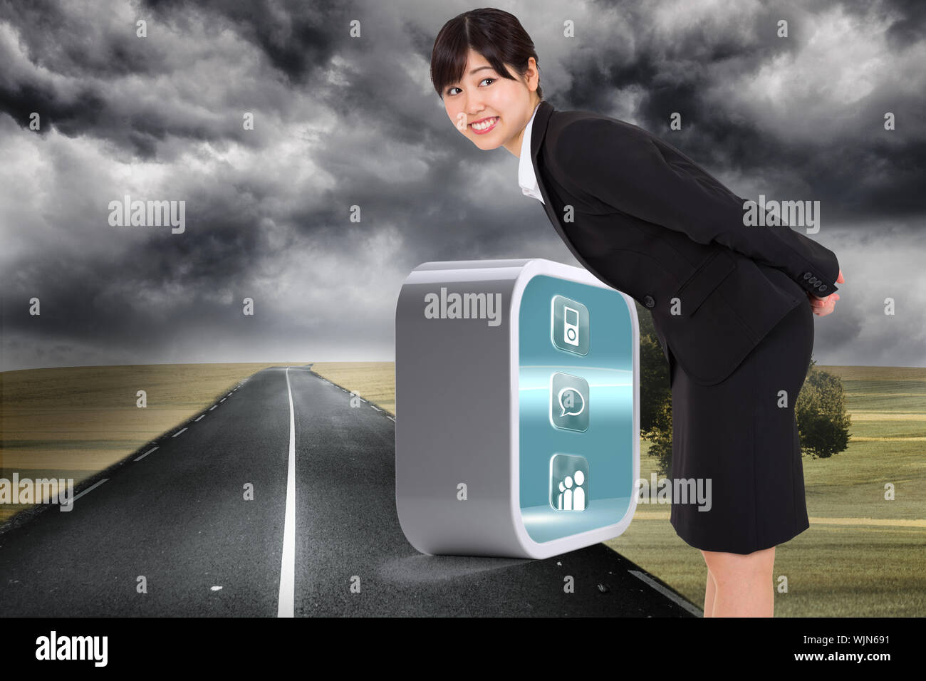 Smiling businesswoman bending against misty green landscape with street ...