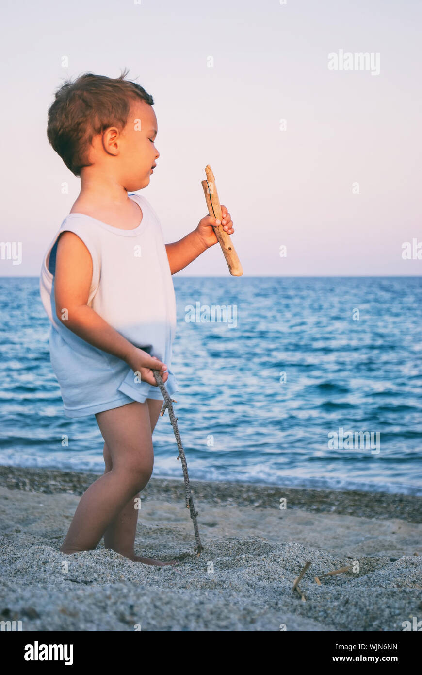 Boys holding sticks hi-res stock photography and images - Alamy