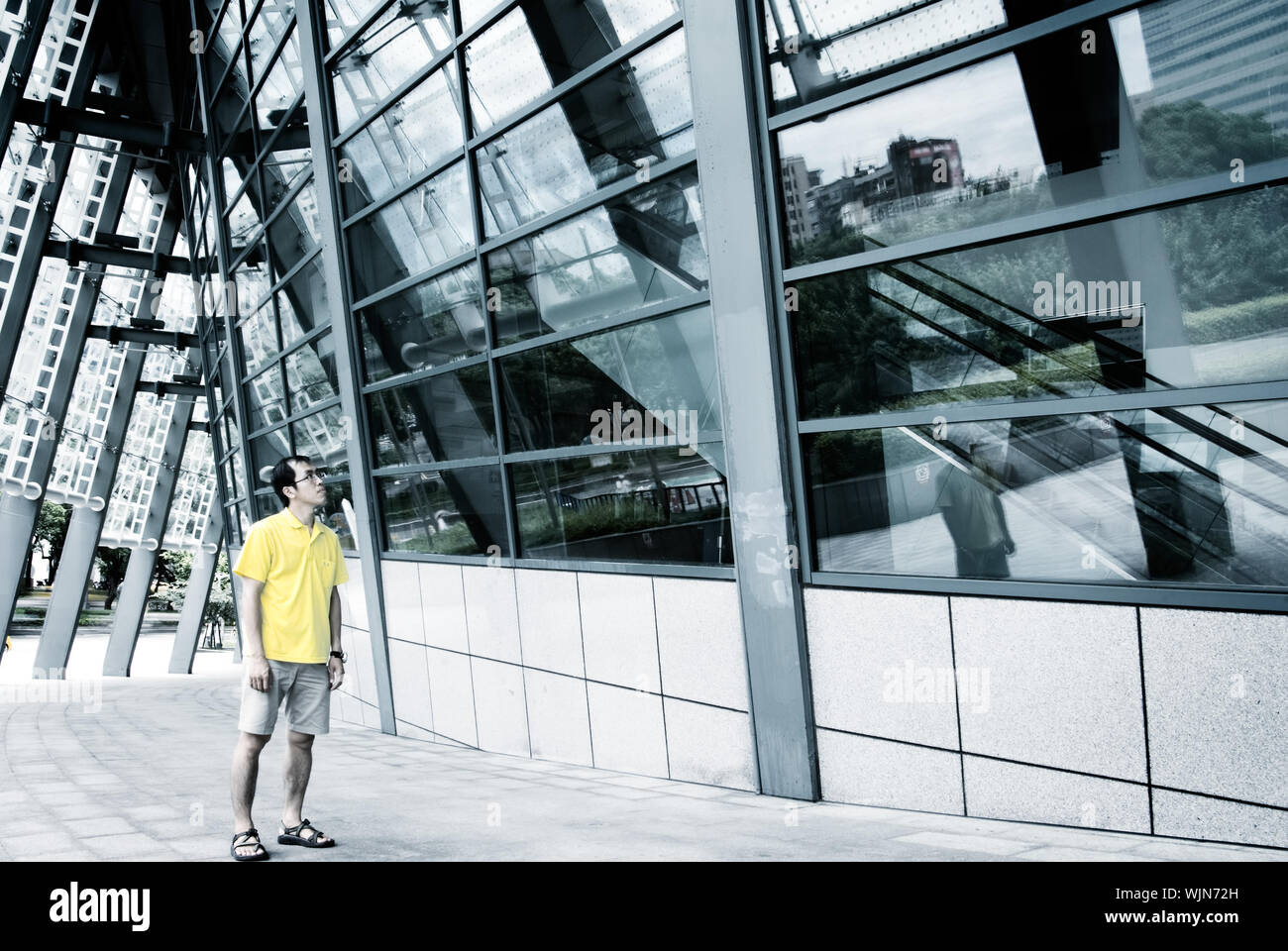 A man standing and watch the modern building Stock Photo - Alamy