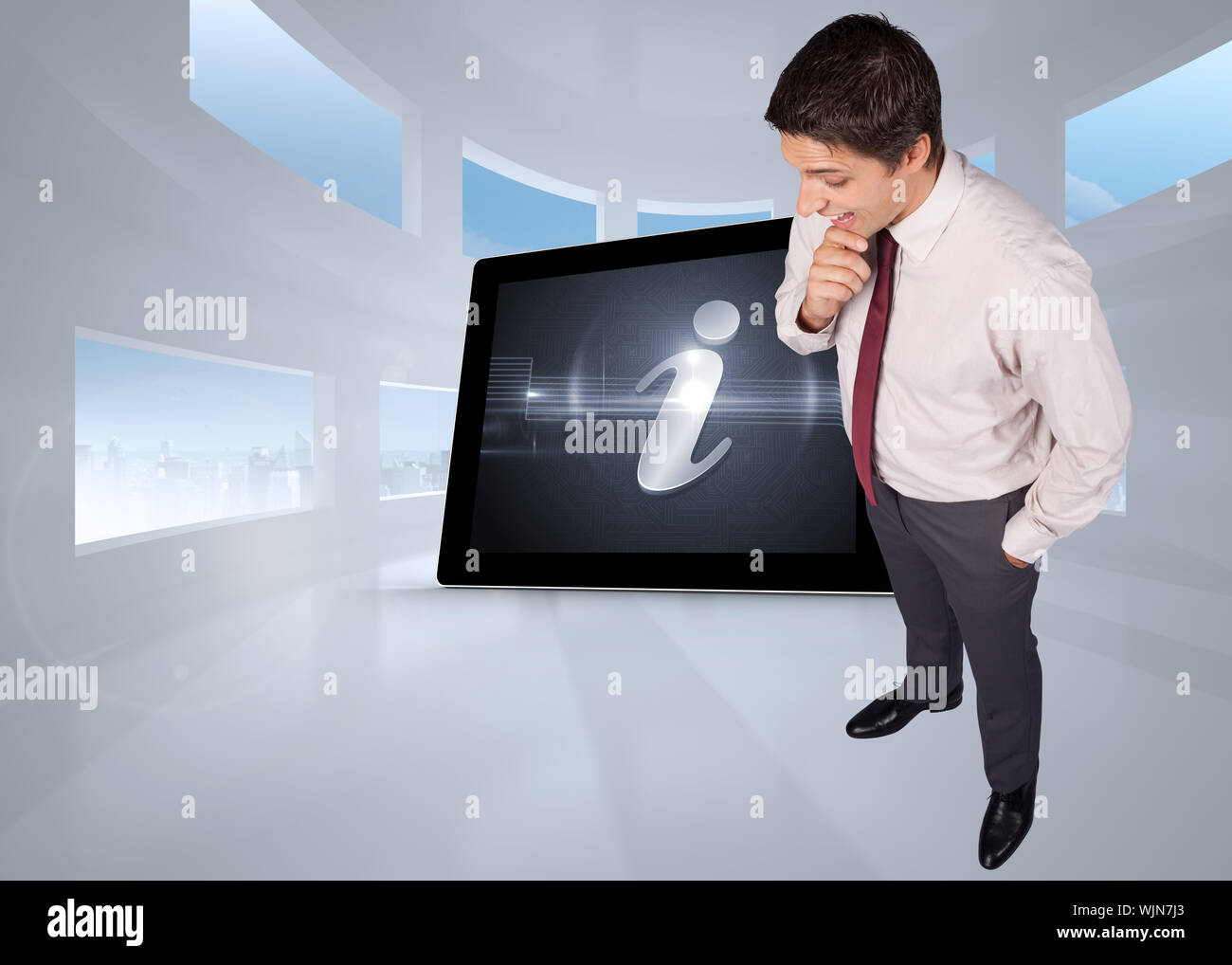 Thinking businessman touching his chin against bright white room with ...