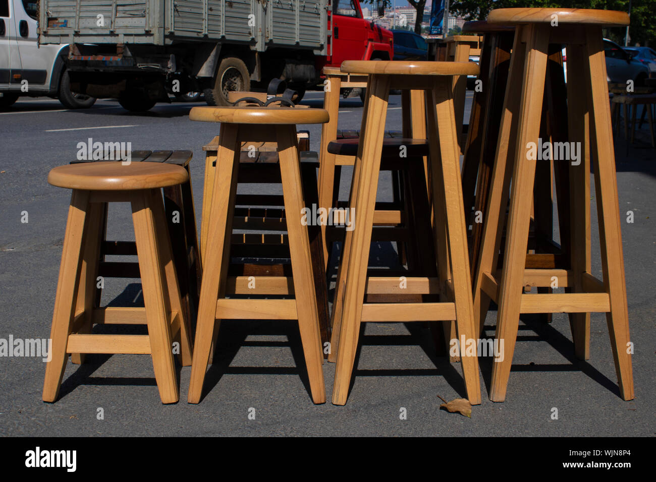 Wooden round stools on the street. Brown and different sizes. Filmed in ...