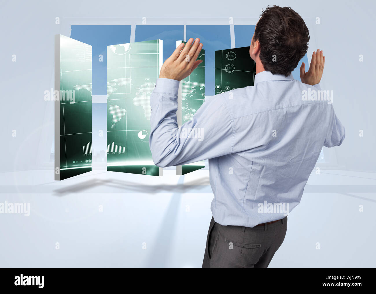 Businessman standing with arms pushing up against bright white room ...