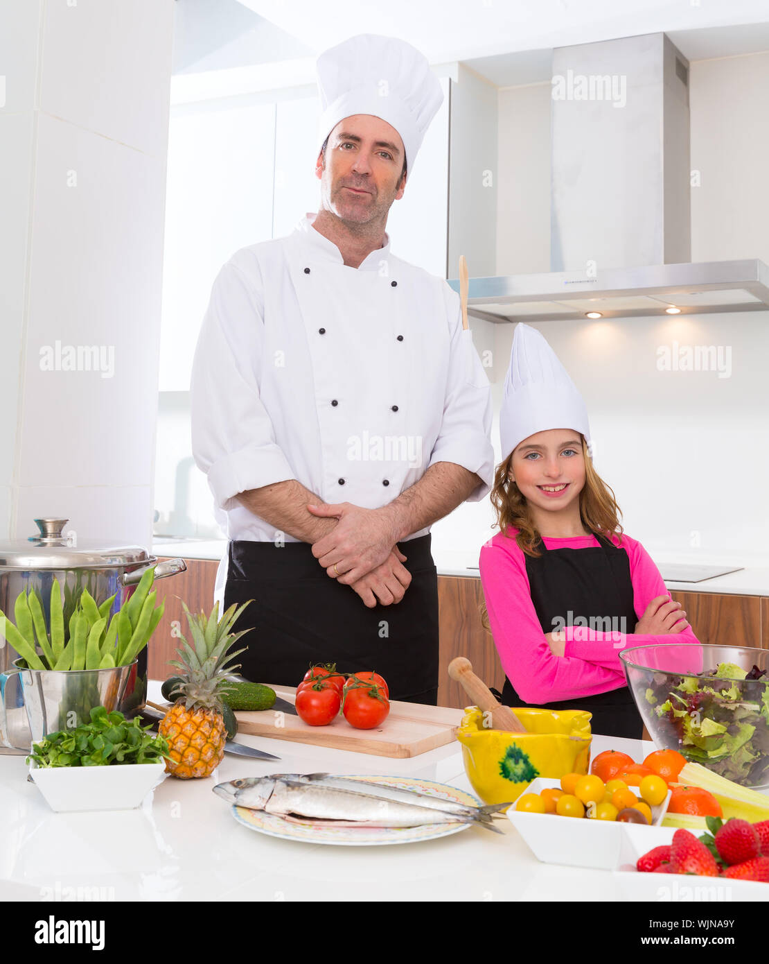 Chef master and junior pupil kid girls at cooking school with food on ...