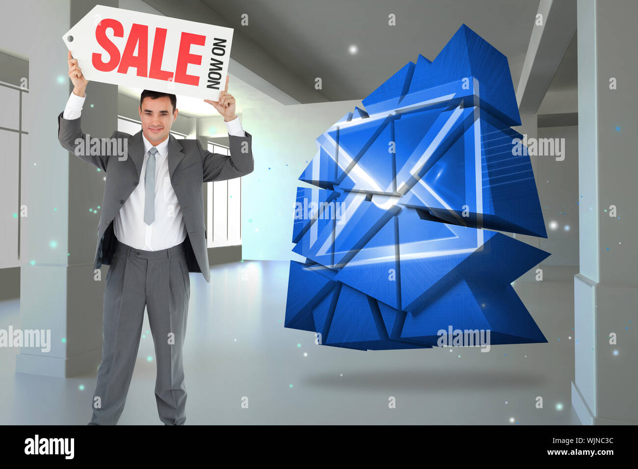 Businessman with sign above his head against screen in room with sparks ...